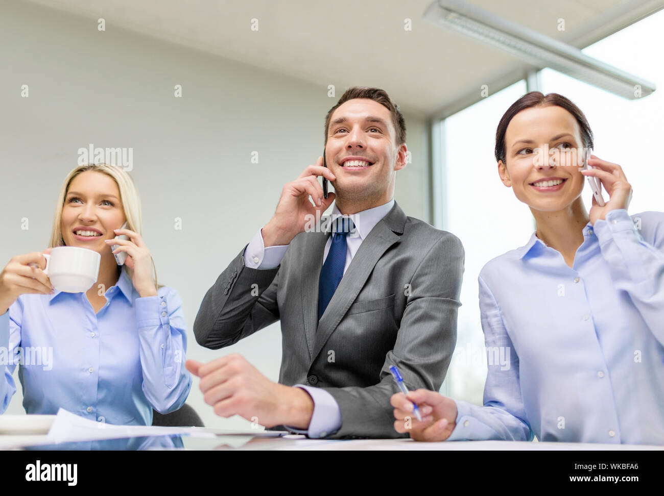 business team with smartphones having conversation Stock Photo - Alamy