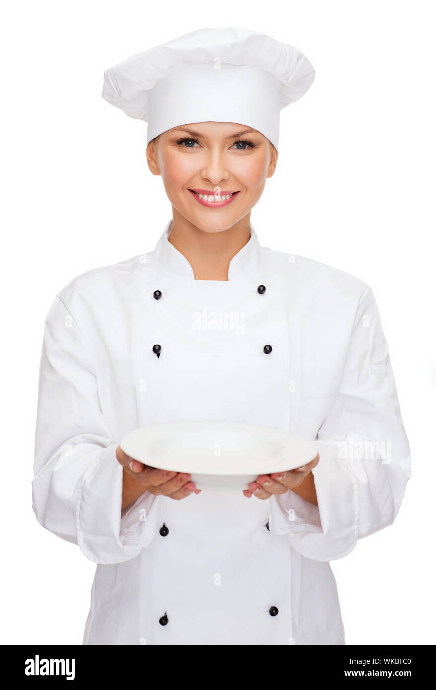 smiling female chef with empty plate Stock Photo - Alamy