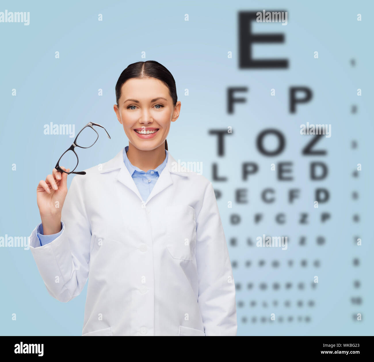 healthcare, vision and medicine concept - smiling female doctor with ...