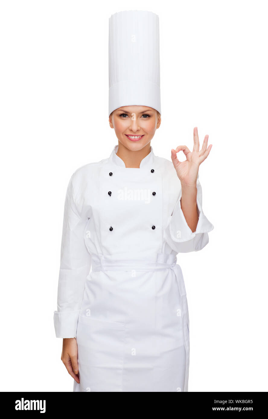 smiling female chef showing ok hand sign Stock Photo - Alamy