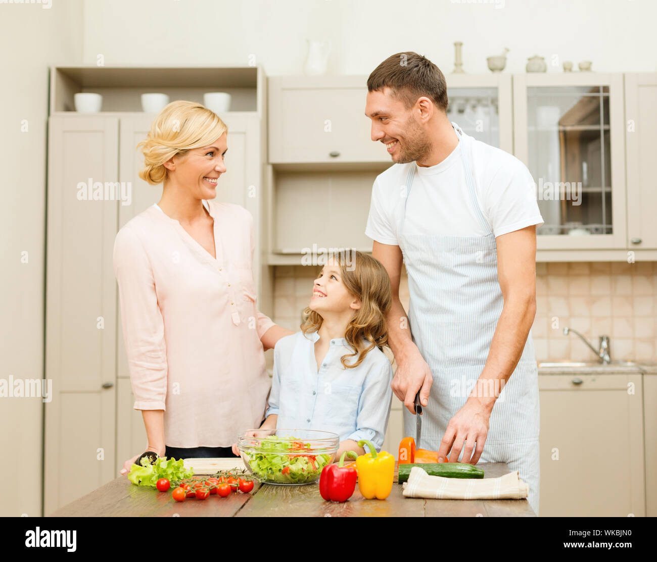 happy family making dinner in kitchen Stock Photo - Alamy