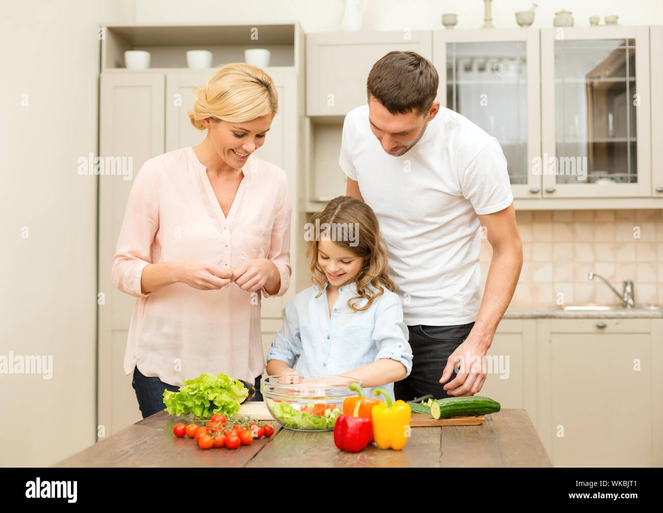 happy family making dinner in kitchen Stock Photo - Alamy