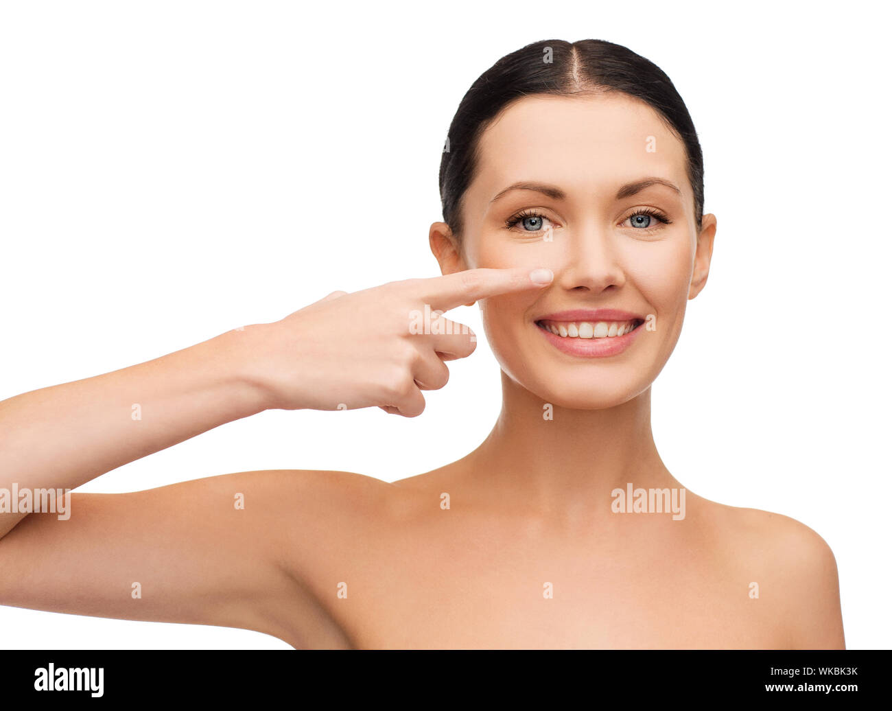 young calm woman pointing to her cheek Stock Photo - Alamy