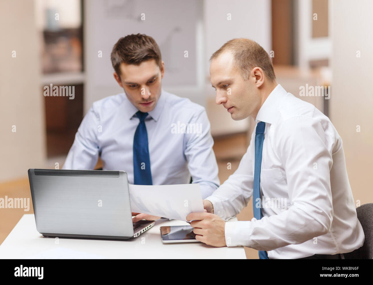 two businessmen having discussion in office Stock Photo - Alamy