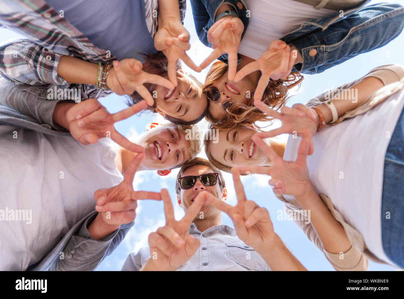 group of teenagers showing finger five Stock Photo - Alamy