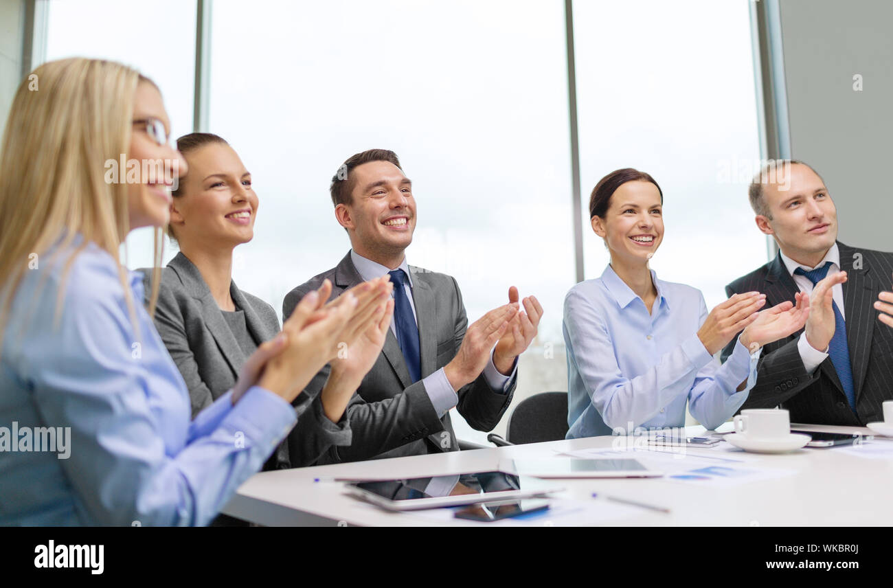 business, technology and office concept - happy business team with ...