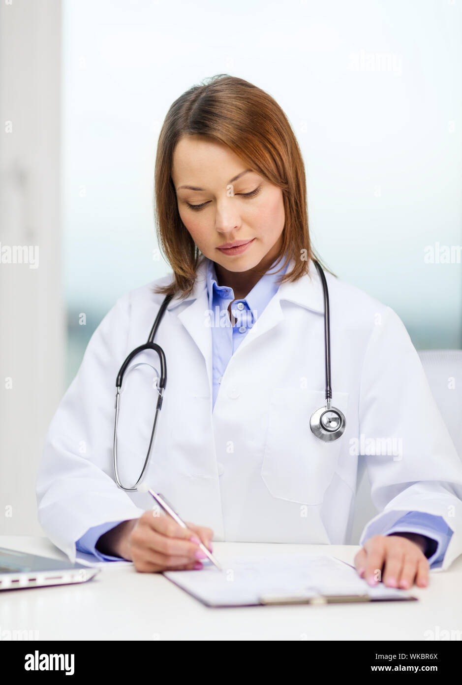 busy doctor with laptop computer Stock Photo - Alamy