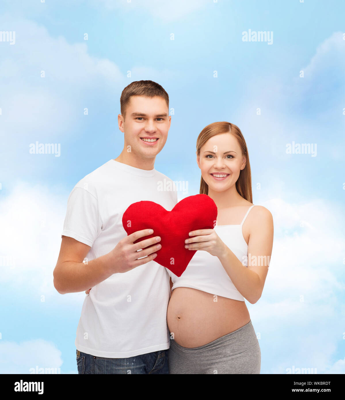 happy young family expecting child with big heart Stock Photo - Alamy