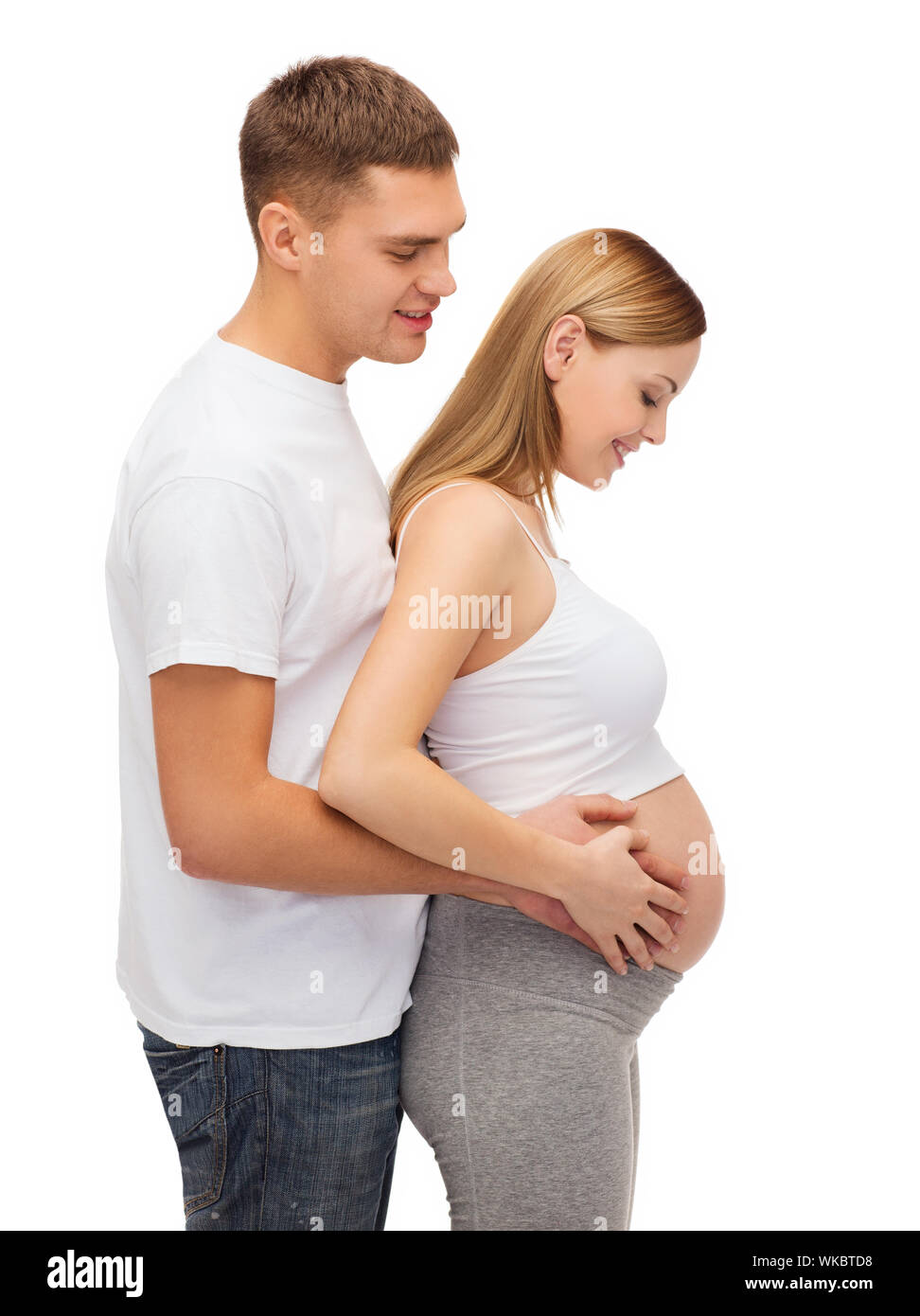 pregnancy, parenthood and happiness concept - happy young family ...
