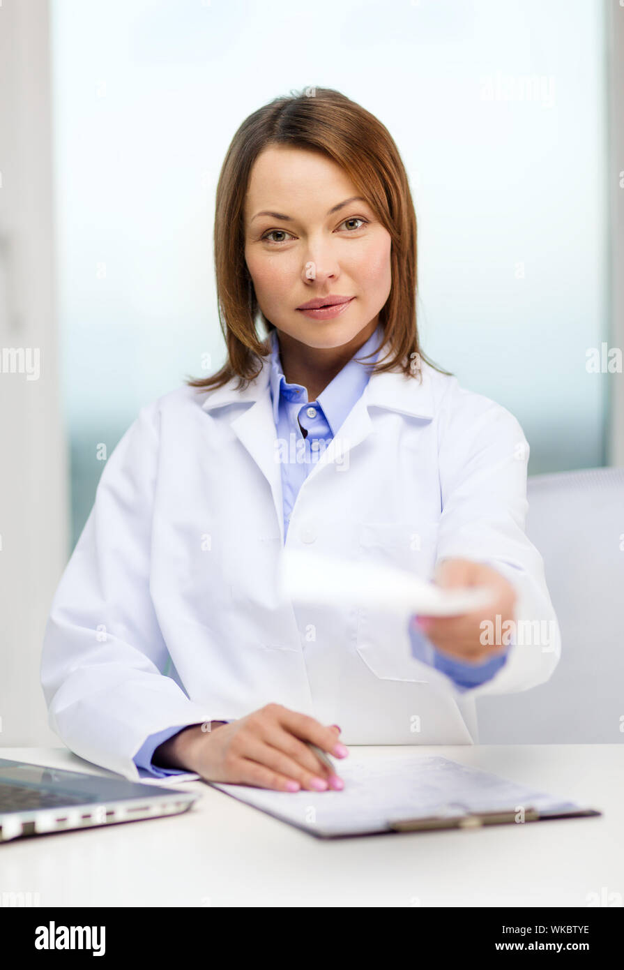 busy doctor with laptop computer and clipboard Stock Photo - Alamy