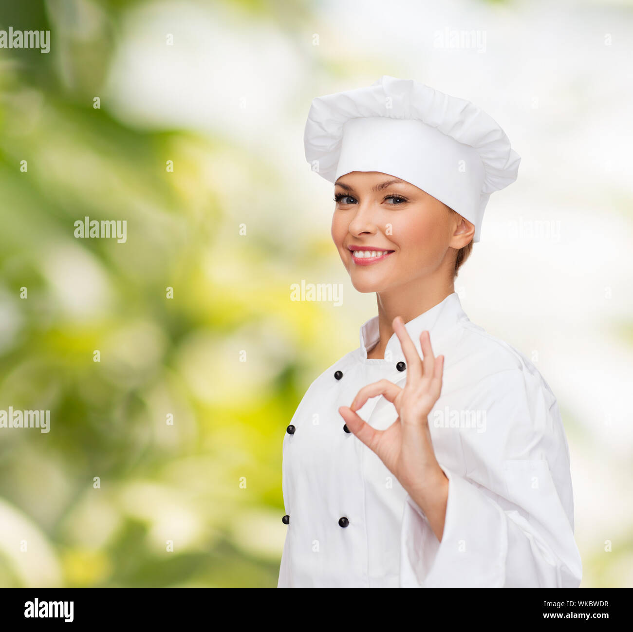 cooking, gesture and food concept - smiling female chef showing ok hand ...