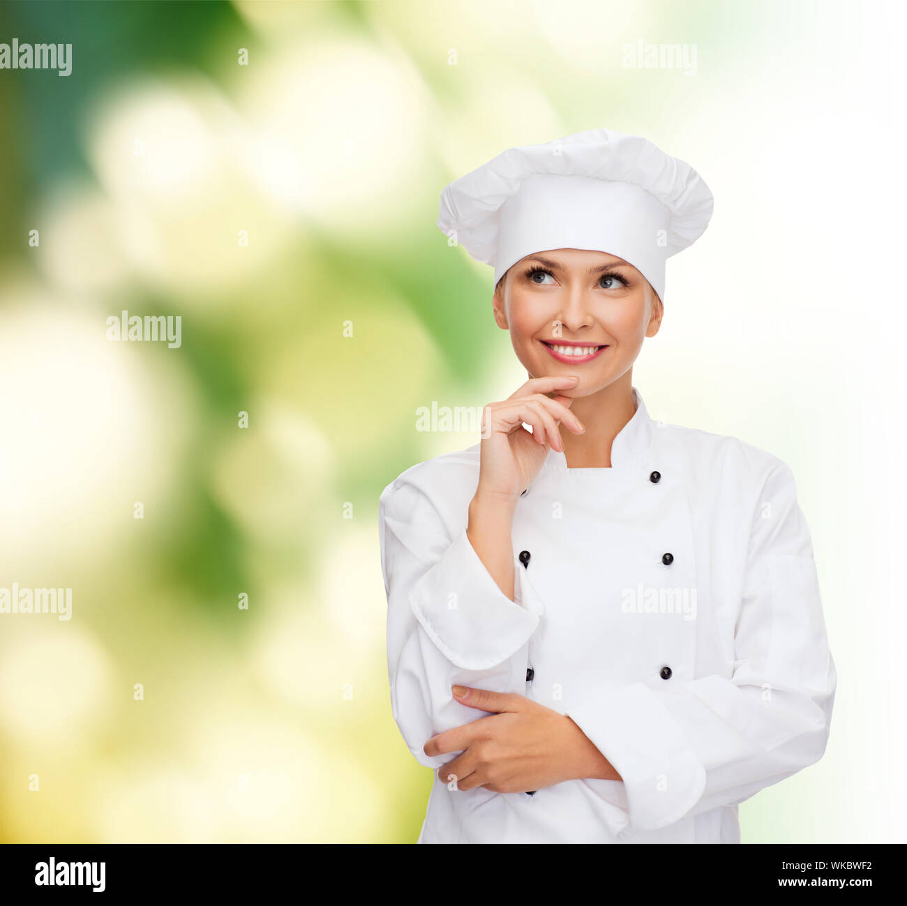 cooking and food concept - smiling female chef, cook or baker dreaming ...