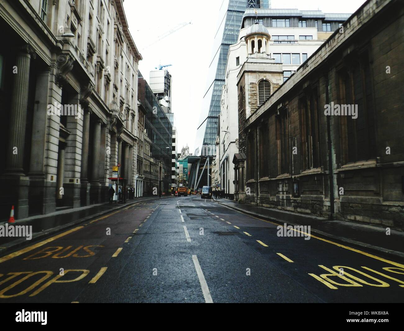 Empty Road Along Built Structures Stock Photo - Alamy