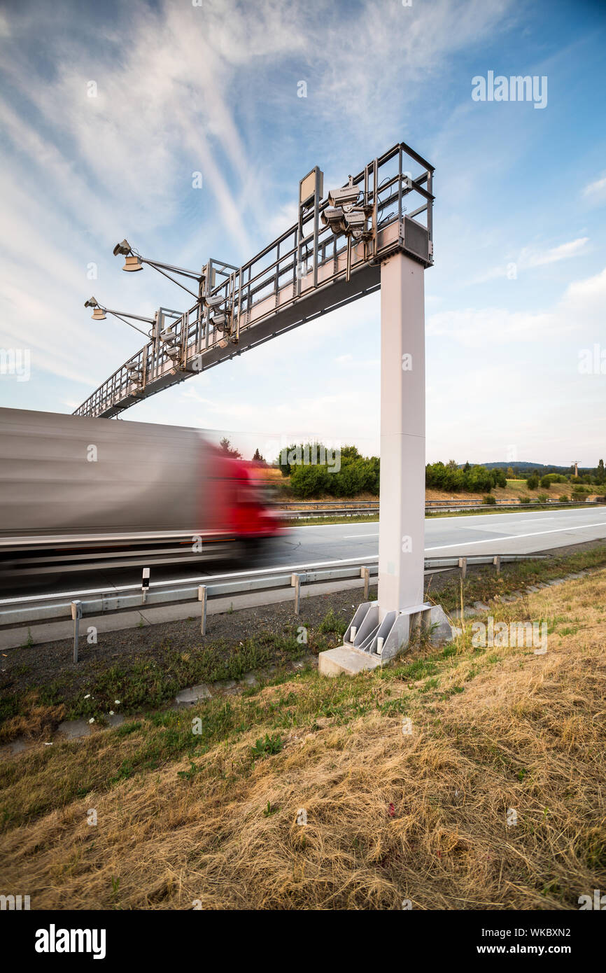 truck passing through a toll gate on a highway (motion blurred image ...