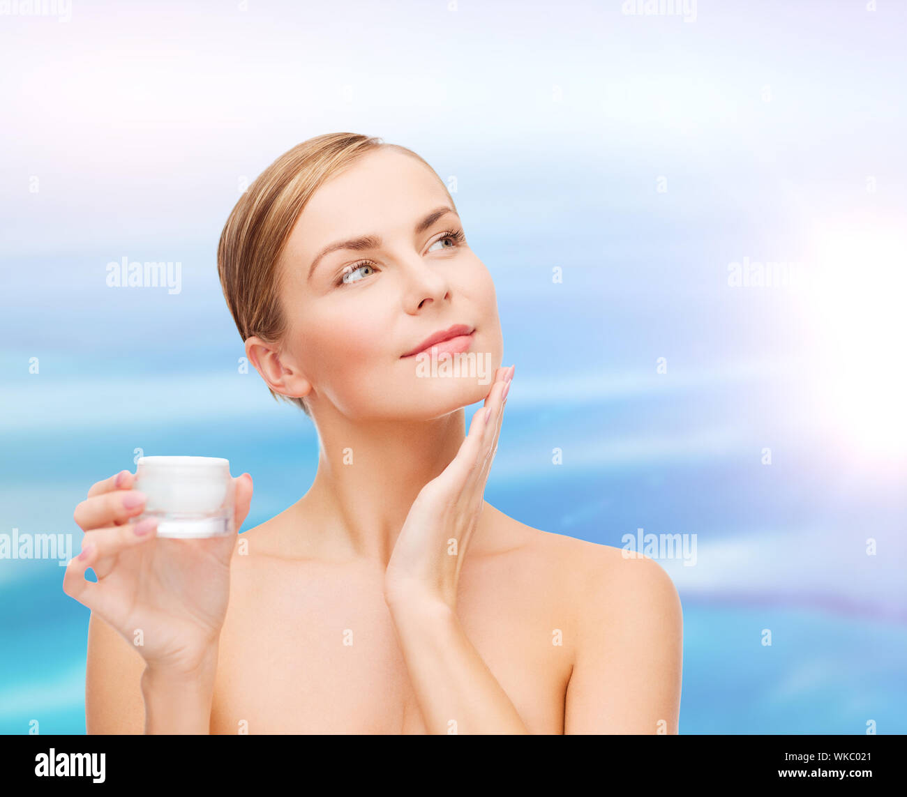 woman applying cream on her skin Stock Photo - Alamy