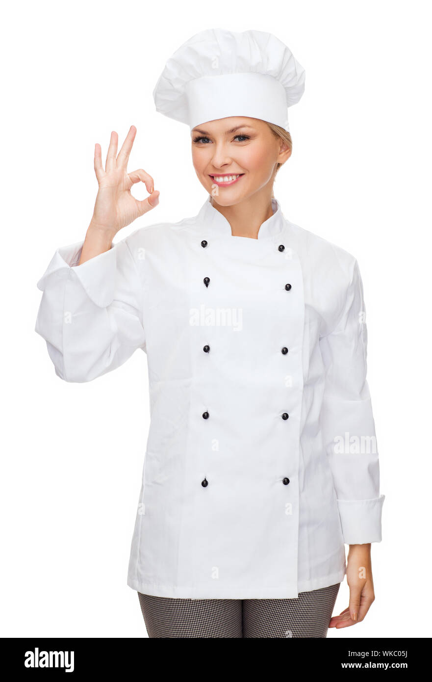 smiling female chef showing ok hand sign Stock Photo - Alamy