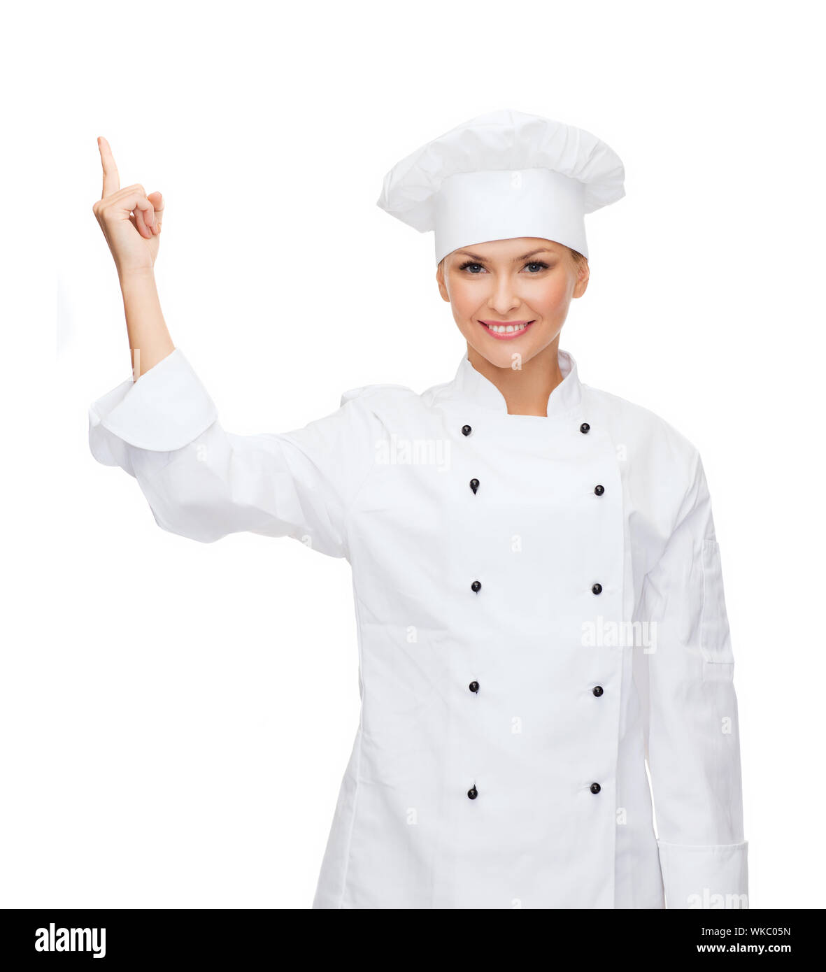 smiling female chef pointing finger to sonething Stock Photo - Alamy