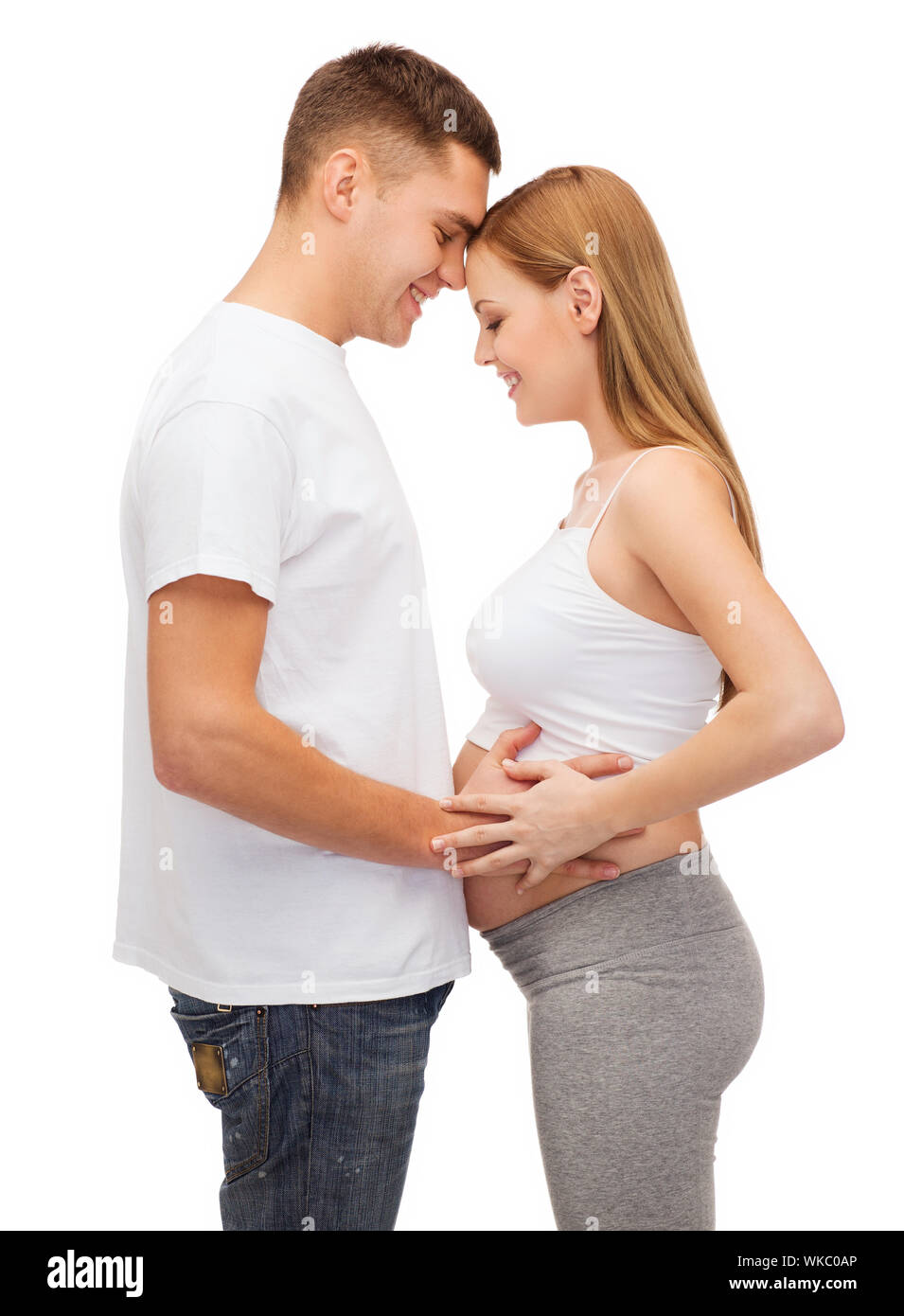 pregnancy, parenthood and happiness concept - happy young family ...