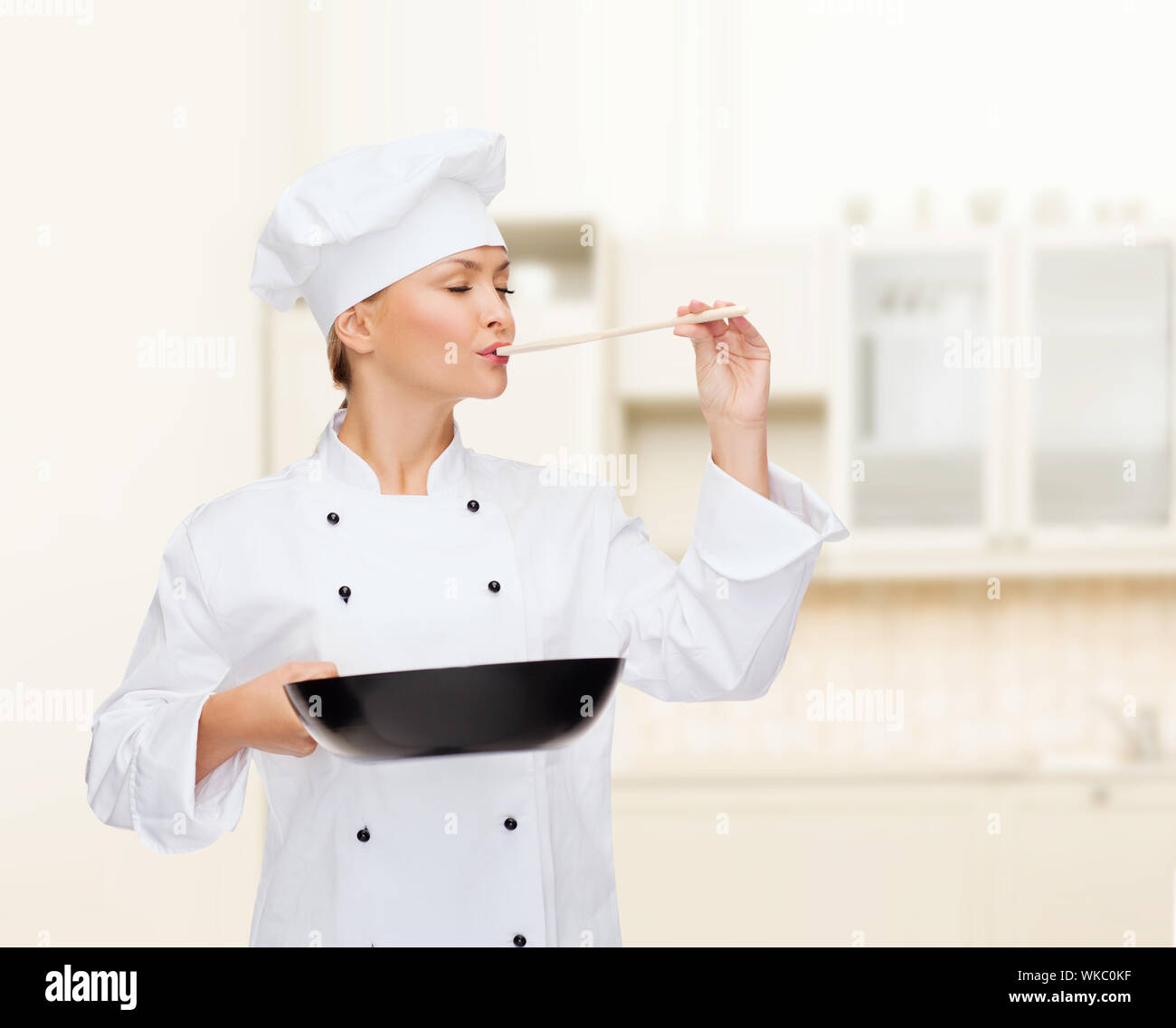 smiling female chef with pan and spoon Stock Photo - Alamy