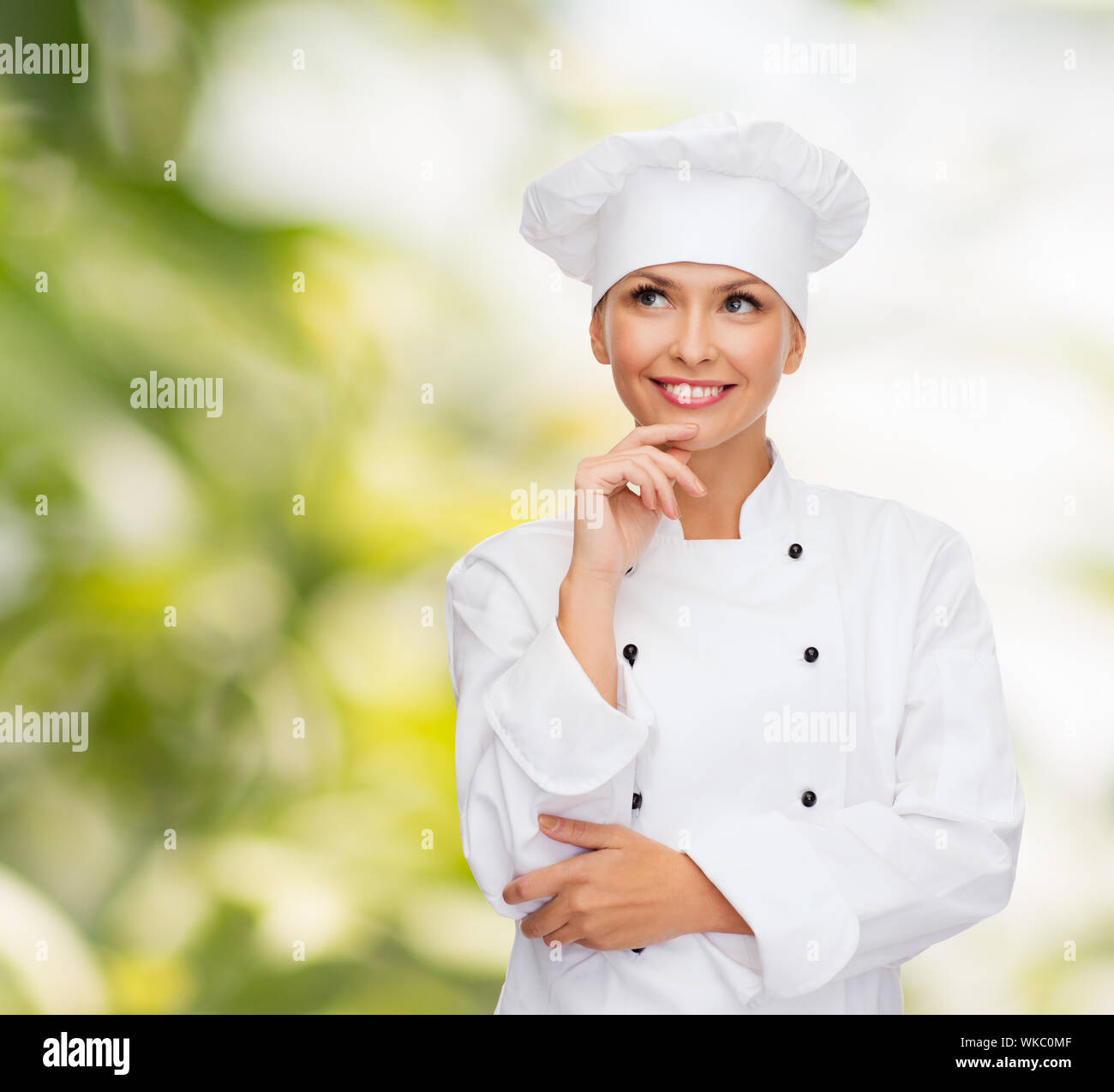 cooking and food concept - smiling female chef, cook or baker dreaming ...