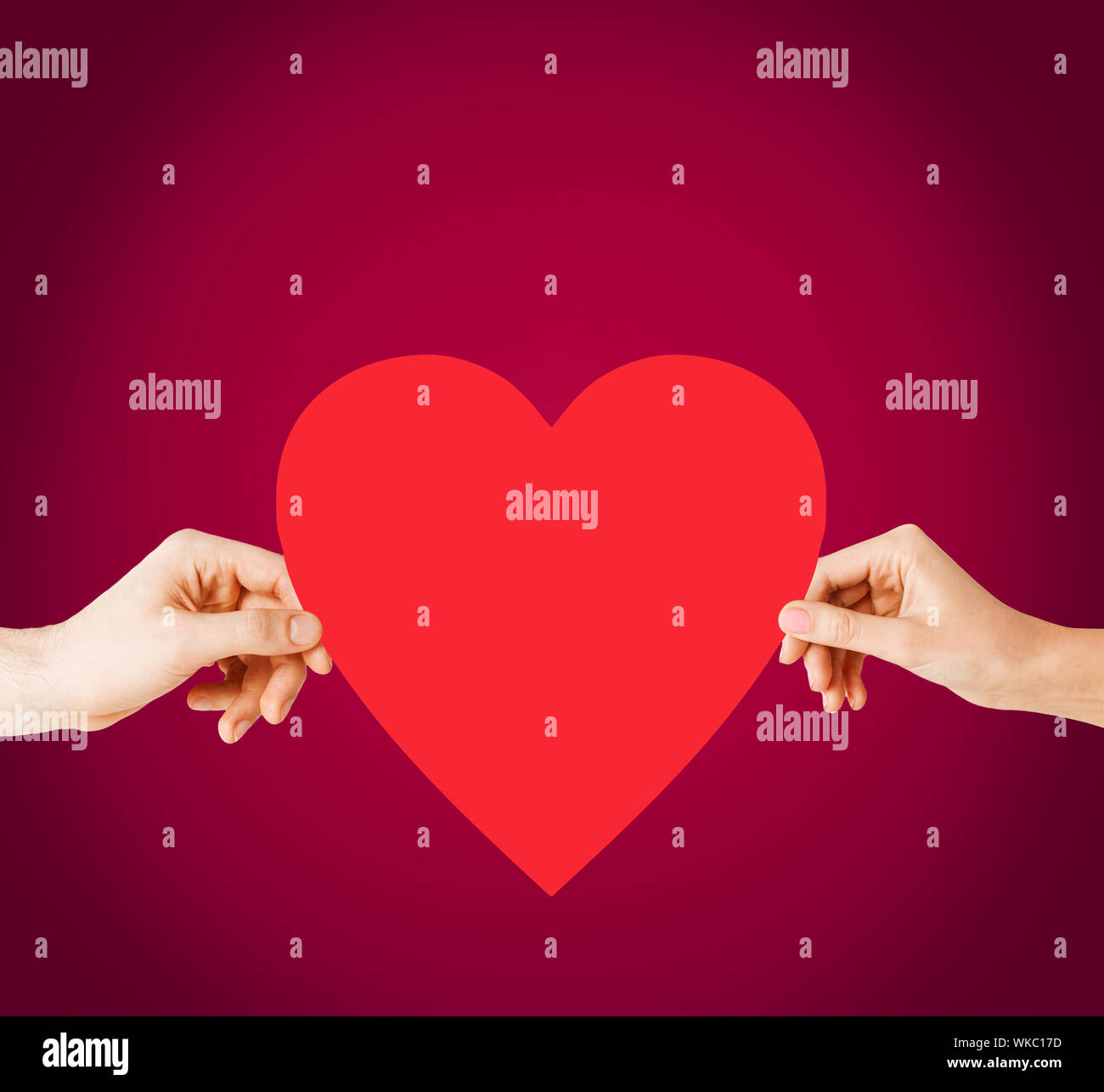 couple hands holding red heart Stock Photo - Alamy