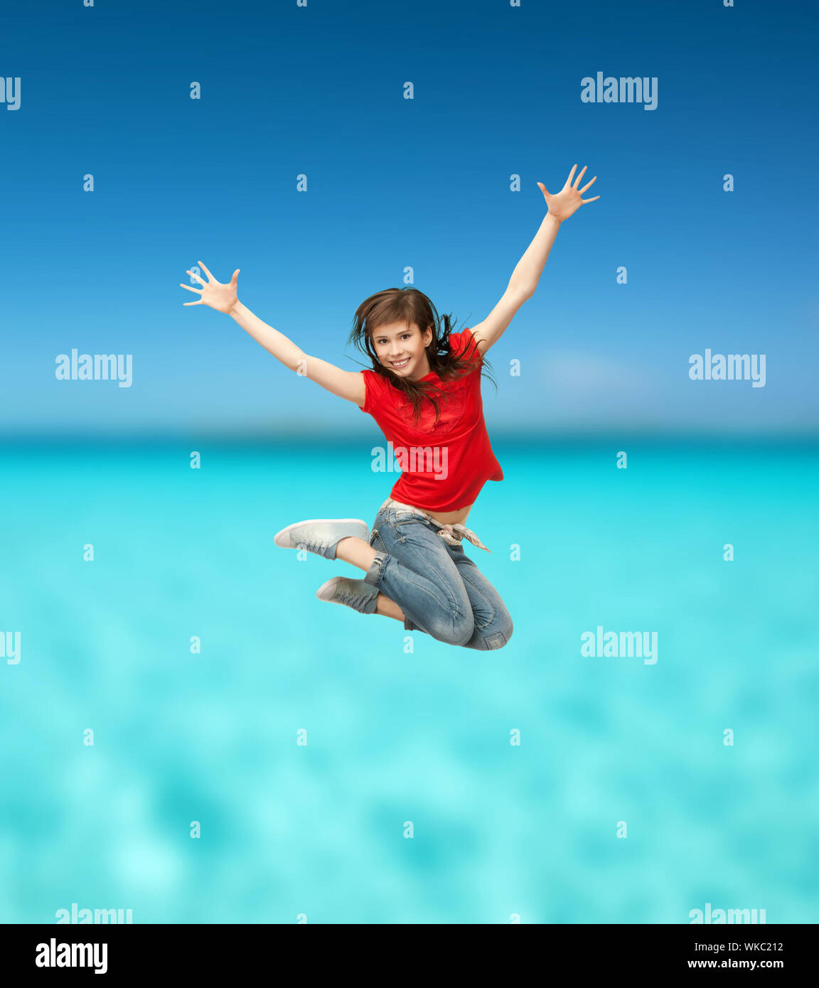 smiling girl jumping Stock Photo - Alamy