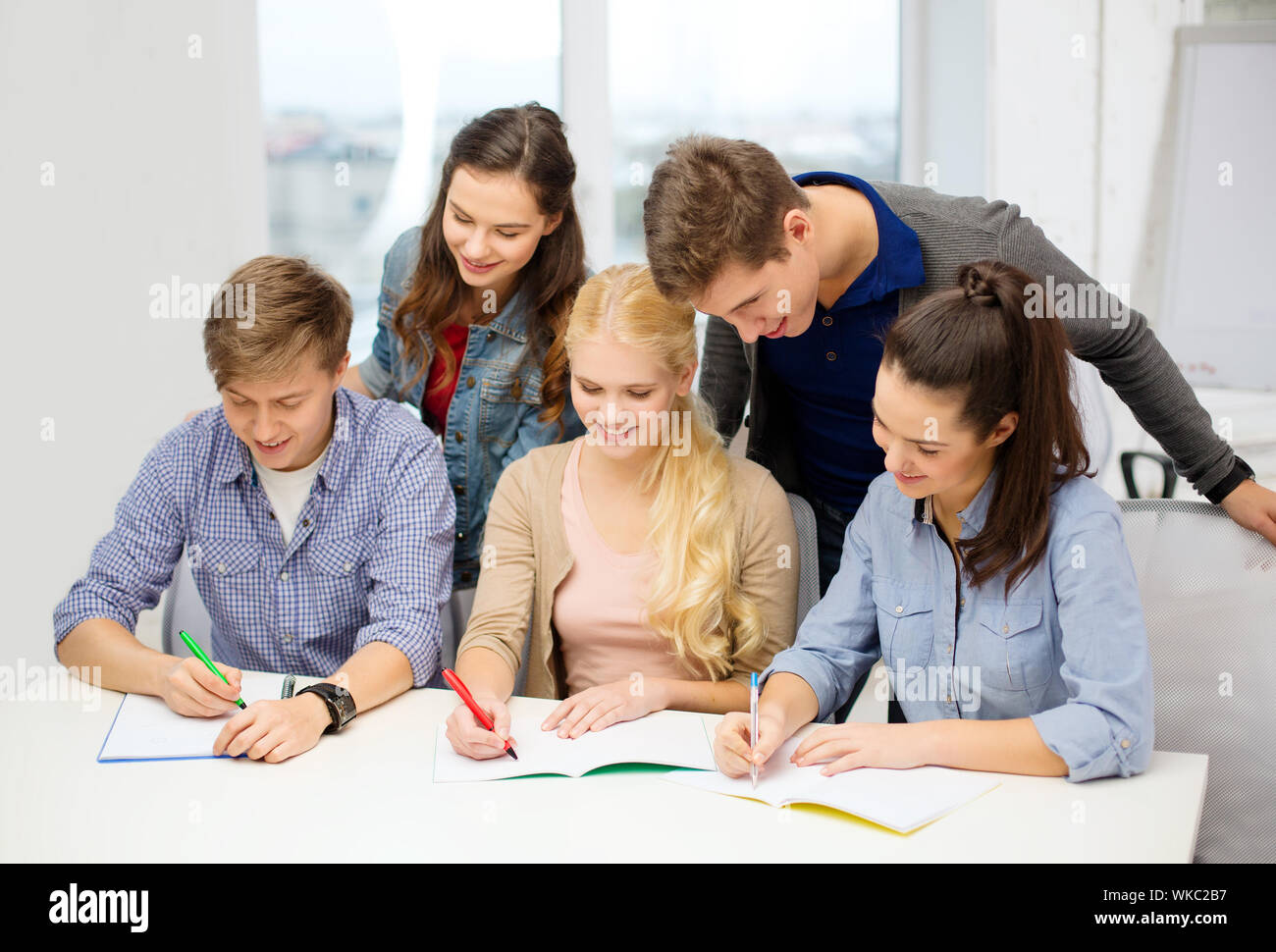 smiling students with notebooks at school Stock Photo - Alamy