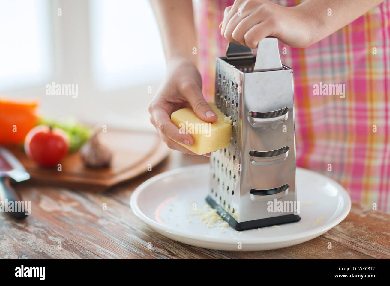 close up of female hands grating cheese Stock Photo - Alamy