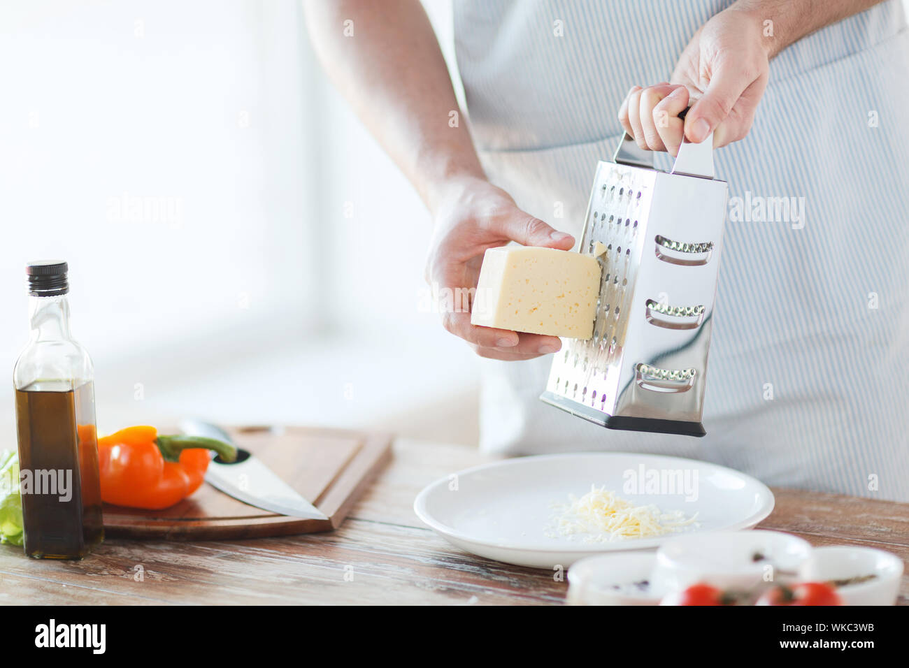 Grating cheese grater hands hi-res stock photography and images - Alamy