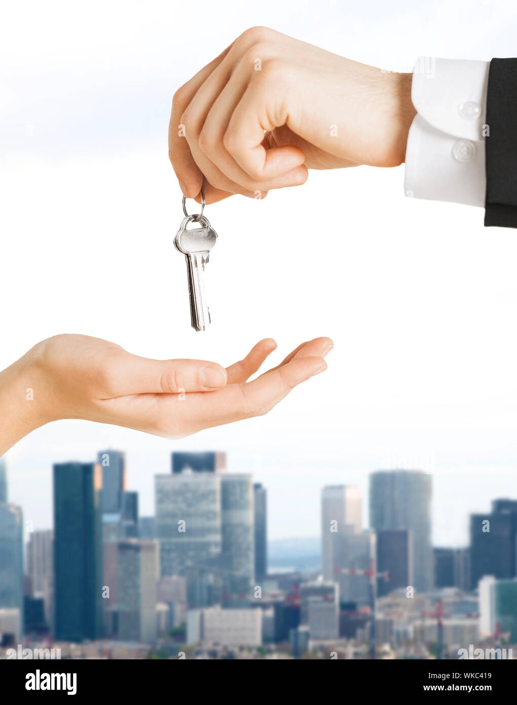 real estate and banking concept - close up of man hand passing house ...