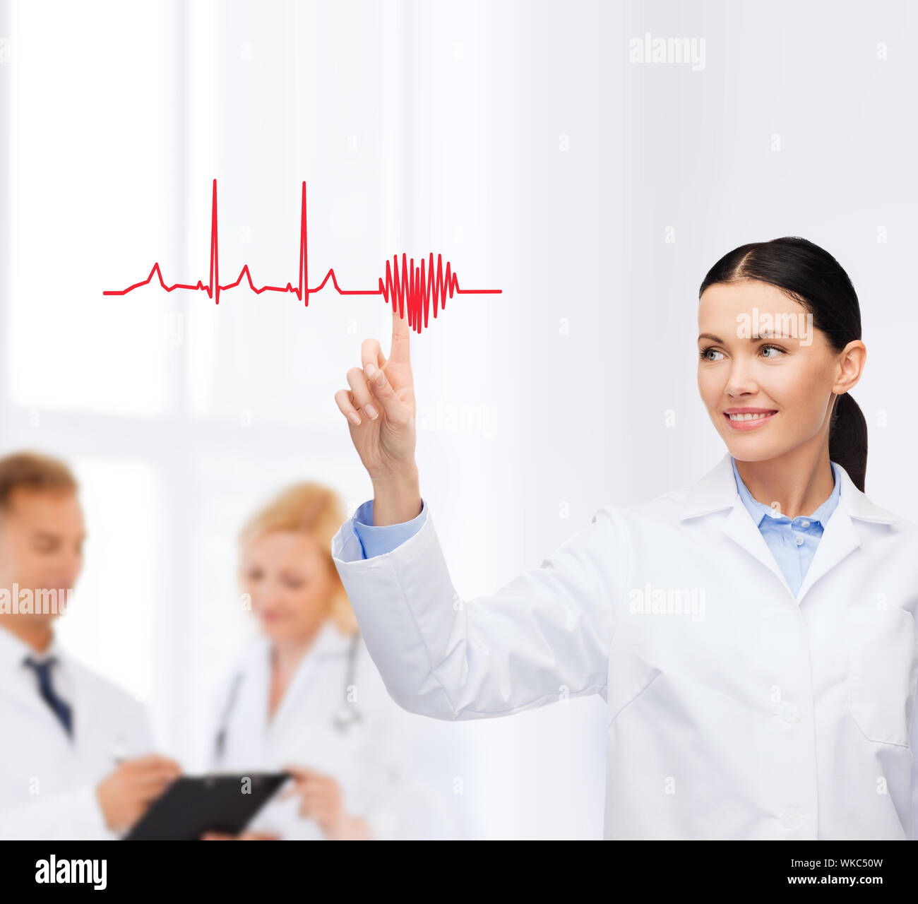 Doctor smiling touching ecg hi-res stock photography and images - Alamy
