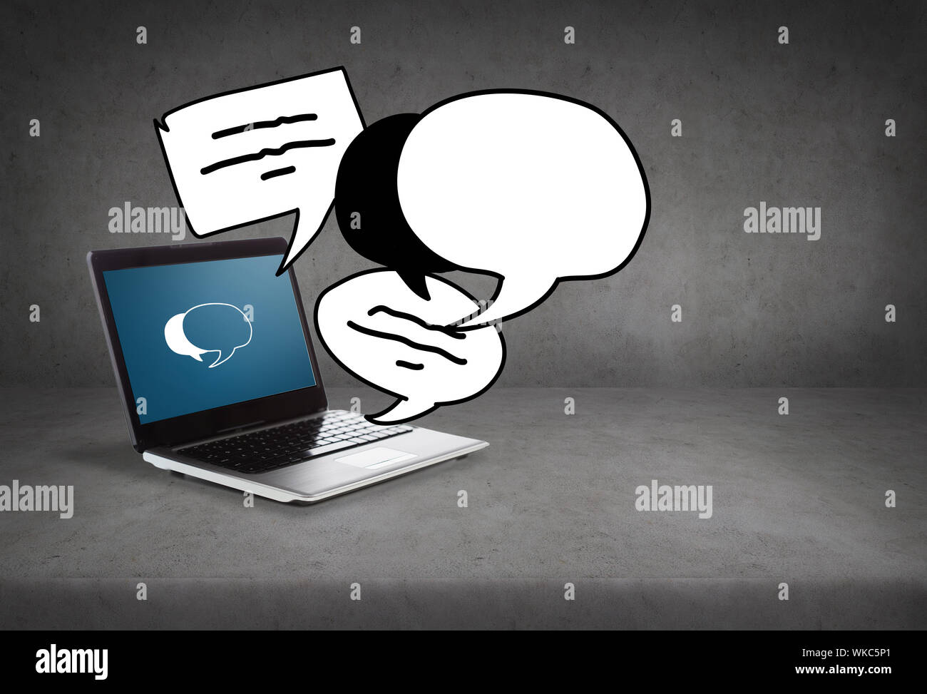 laptop computer with text bubbles on screen Stock Photo - Alamy