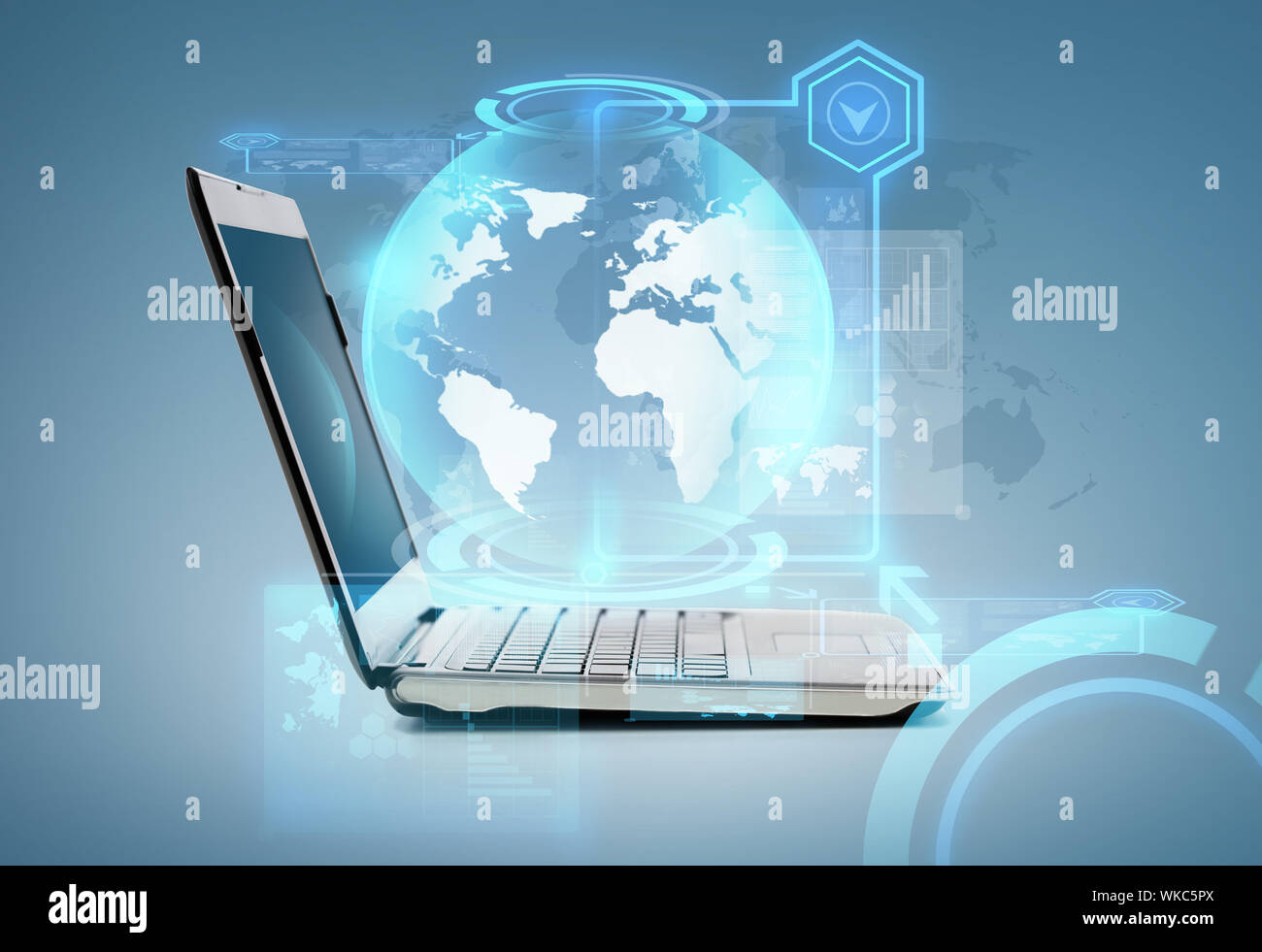technology and advertisement concept - laptop computer with globe ...