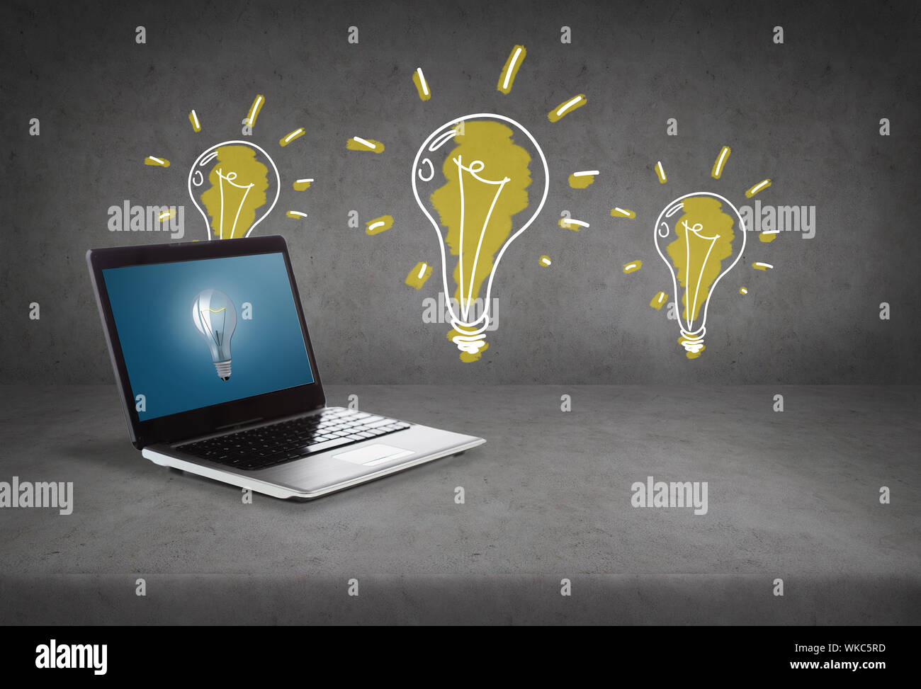 technology and advertisement concept - laptop computer with light bulb ...