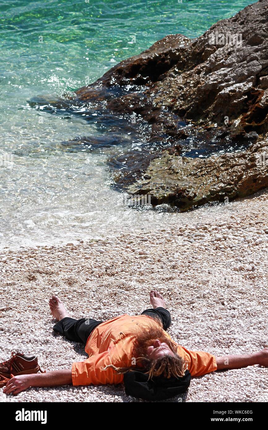 Man Lying On Sand At Beach Stock Photo - Alamy