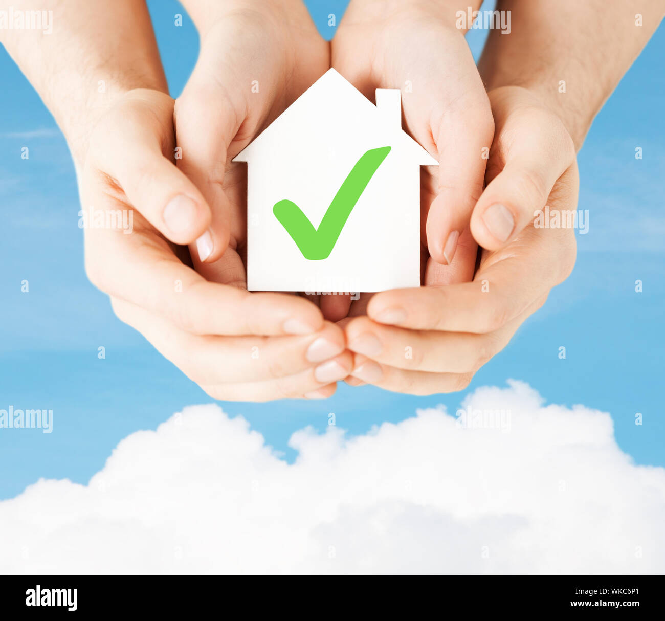 hands holding house with check mark Stock Photo - Alamy