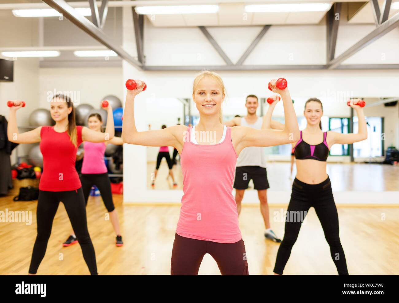 group of smiling people working out with dumbbells Stock Photo - Alamy