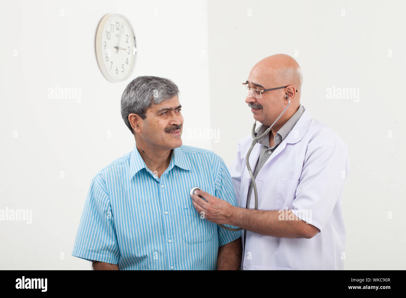 Male doctor examining his patient Stock Photo - Alamy