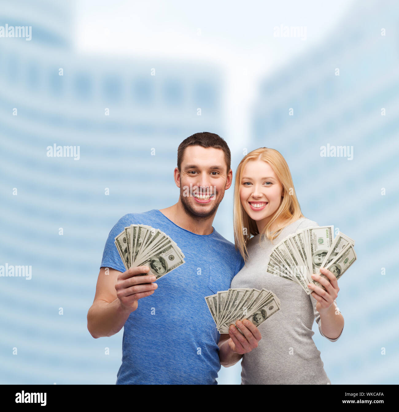 finance, money and family concept - smiling couple holding dollar cash ...