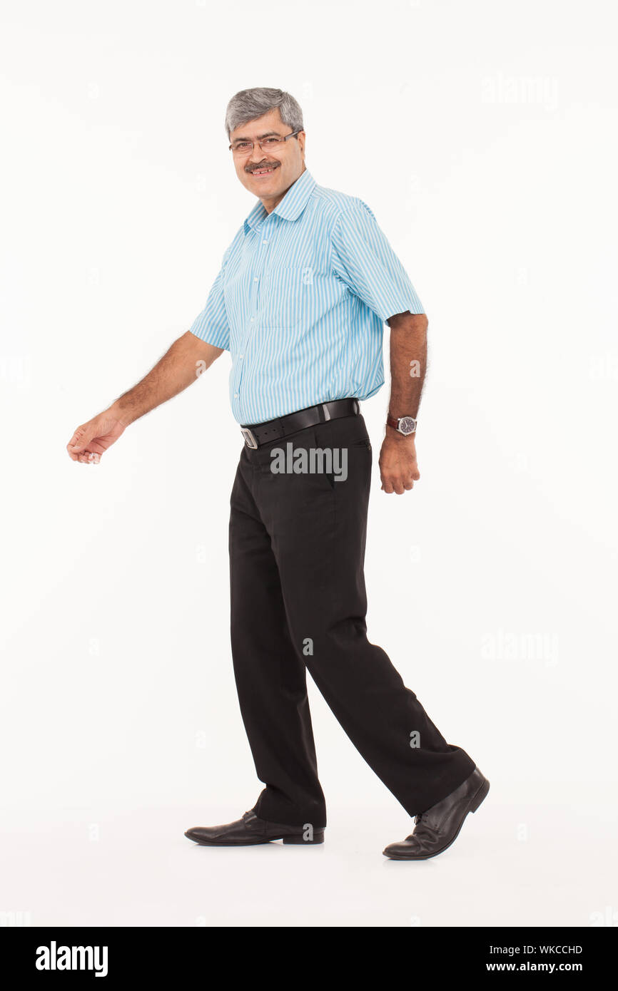 Portrait of a businessman walking Stock Photo - Alamy