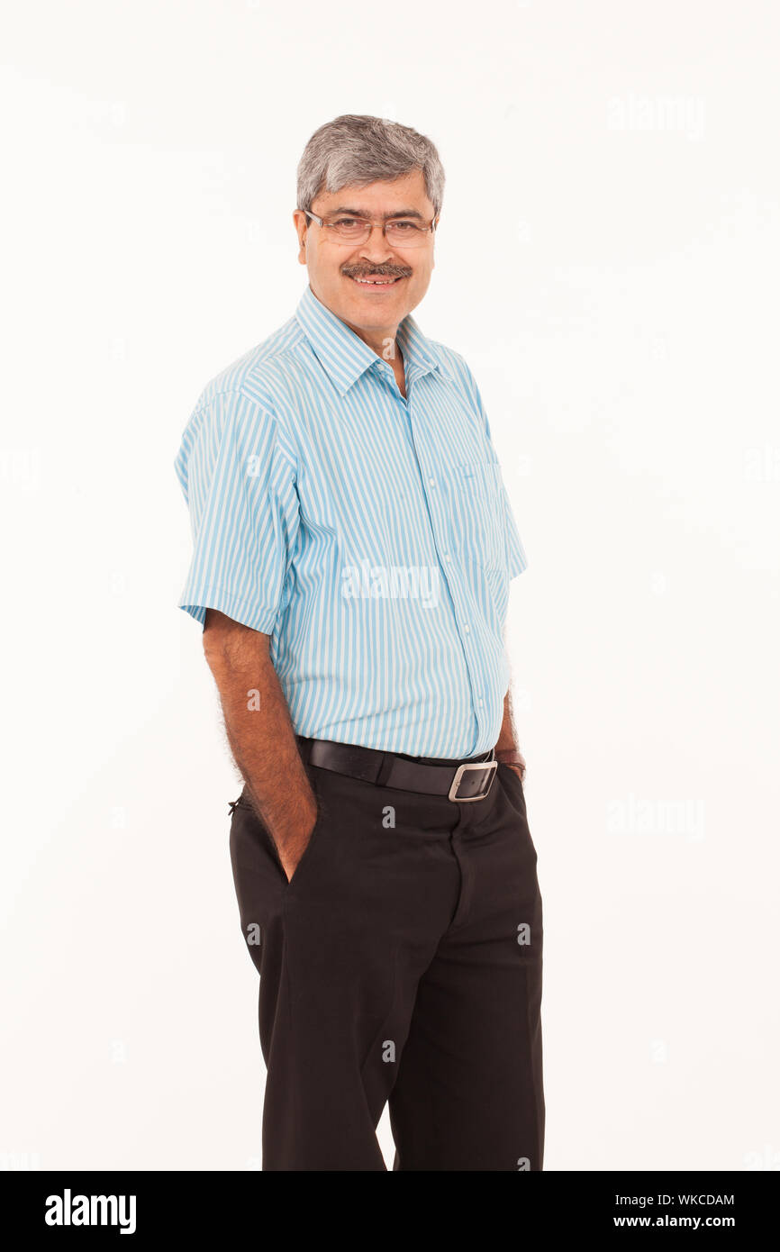 Businessman smiling with his hands in pockets Stock Photo - Alamy