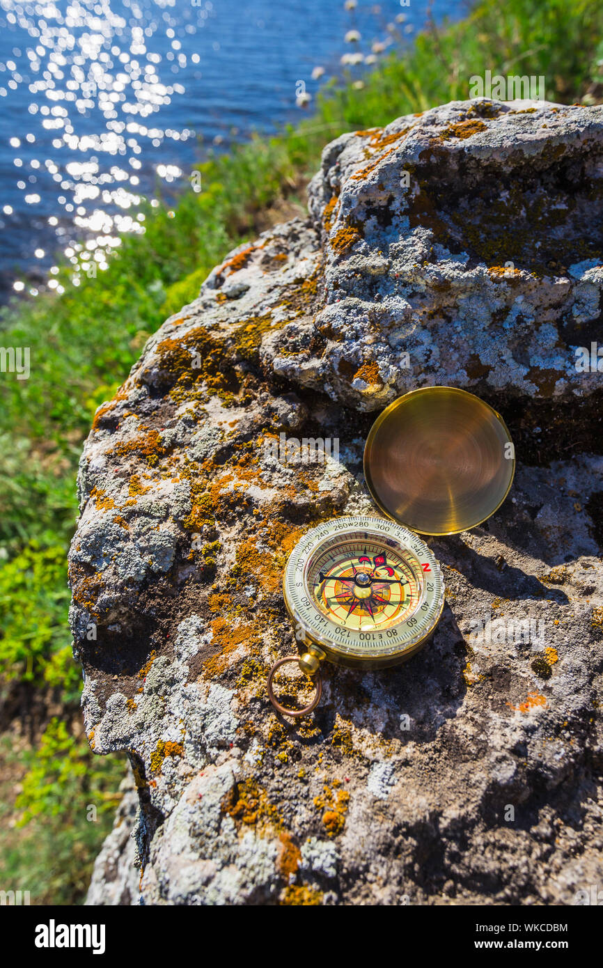 Orientation Concept - Compass Abandoned on the Rocks Stock Photo - Alamy
