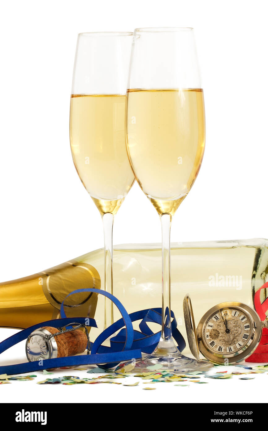 two glasses with champagne, old pocket watch, streamer, cork and ...