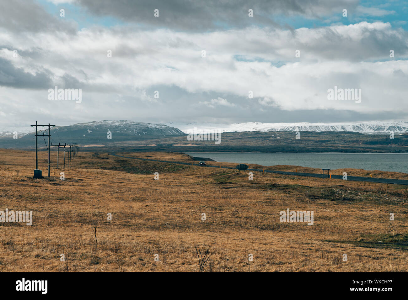 Huge wide open flat landscape with a road and telephone poles, Iceland ...