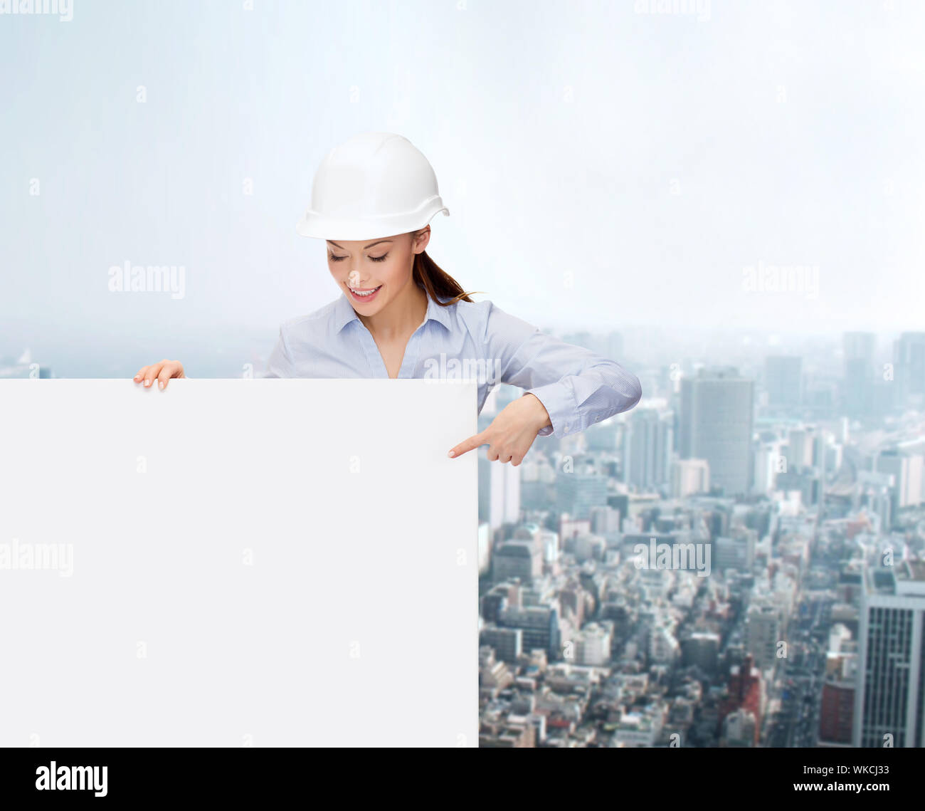 businesswoman in helmet pointing finger to board Stock Photo - Alamy