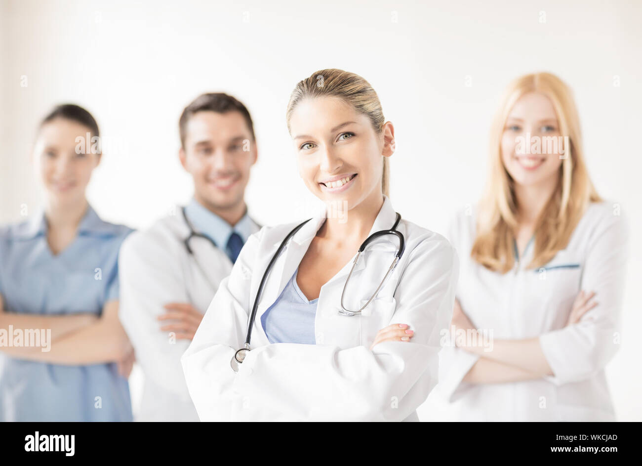 attractive female doctor in front of medical group Stock Photo - Alamy