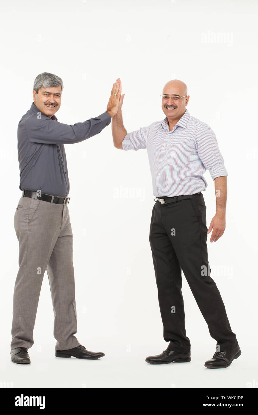 Two business executives giving high fives Stock Photo - Alamy