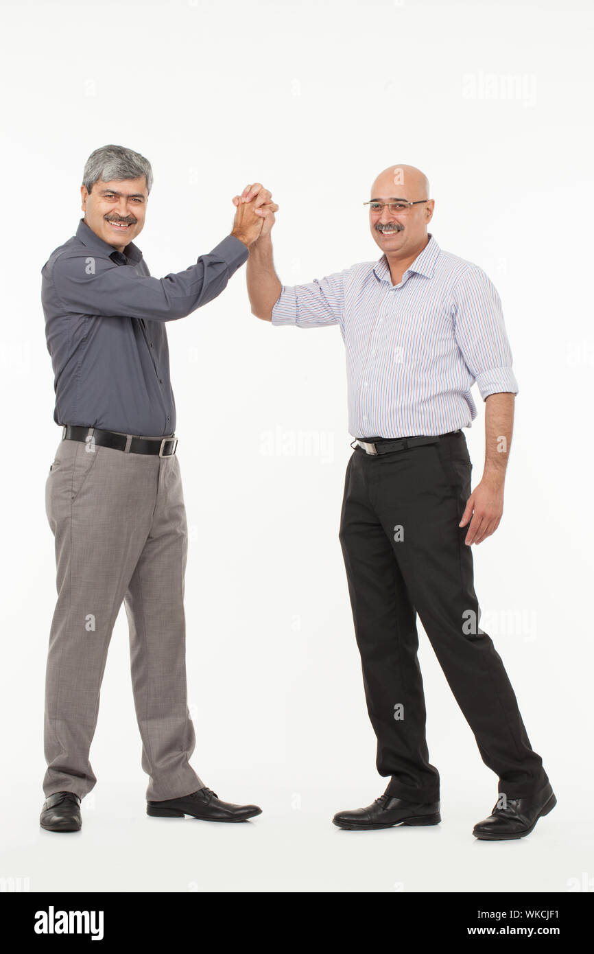 Two business executives giving high fives Stock Photo - Alamy