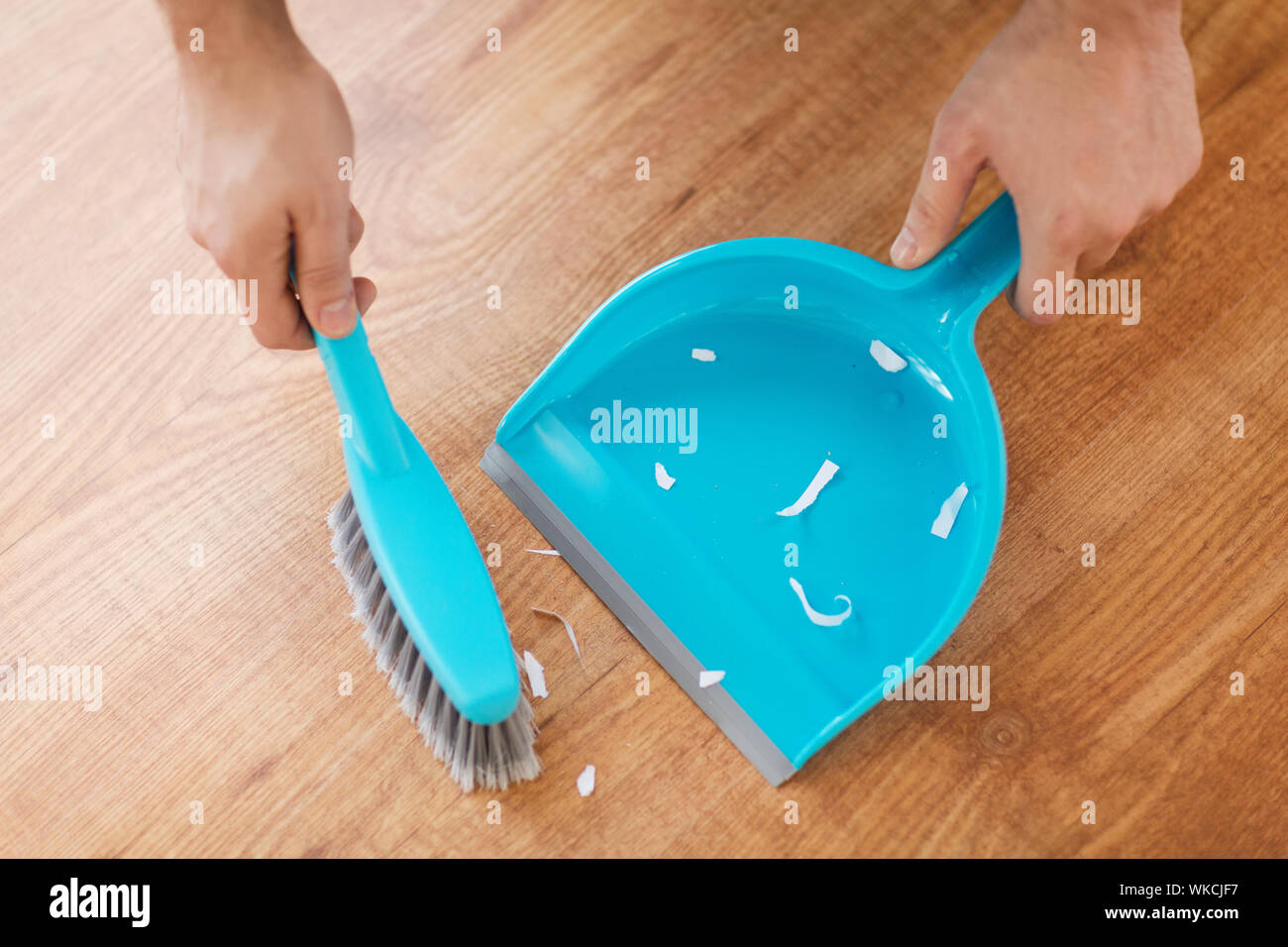Man sweeping floor dustpan broom hi-res stock photography and images ...