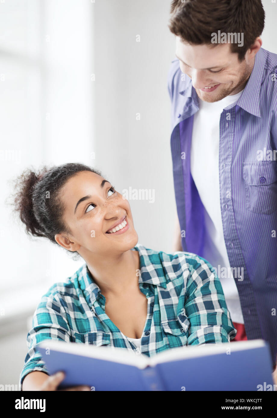 students reading book at school Stock Photo - Alamy